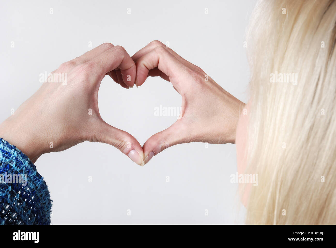 Woman making heart shape with her hands Stock Photo - Alamy