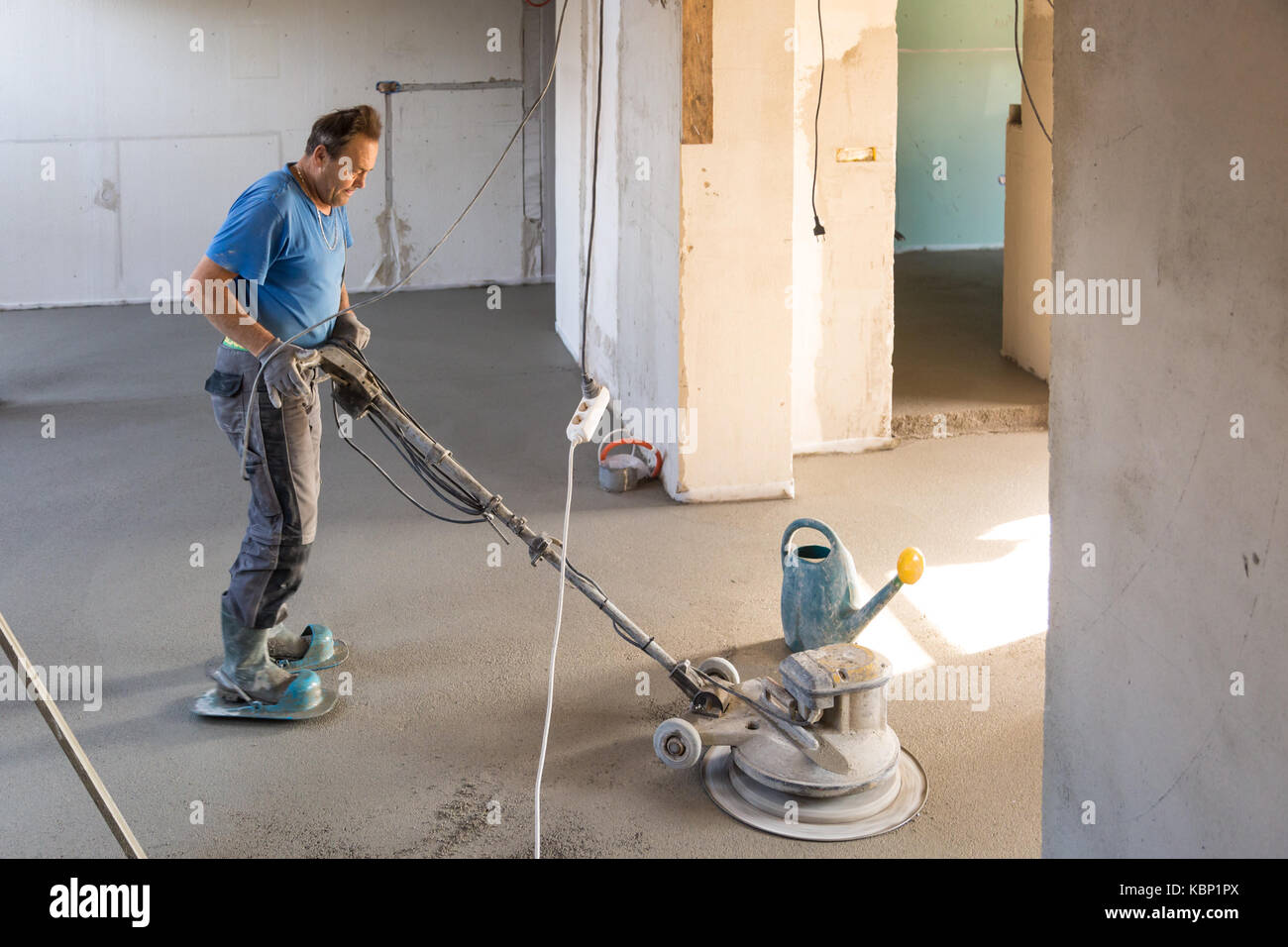 Laborer polishing sand and cement screed floor Stock Photo - Alamy