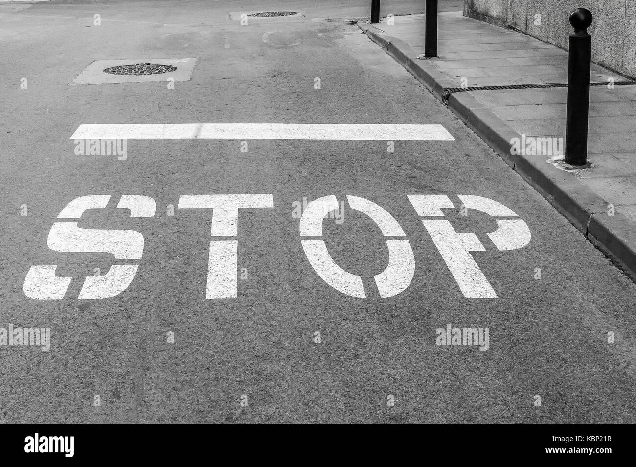 On the asphalt roadway marked the road marking "STOP Stock Photo - Alamy