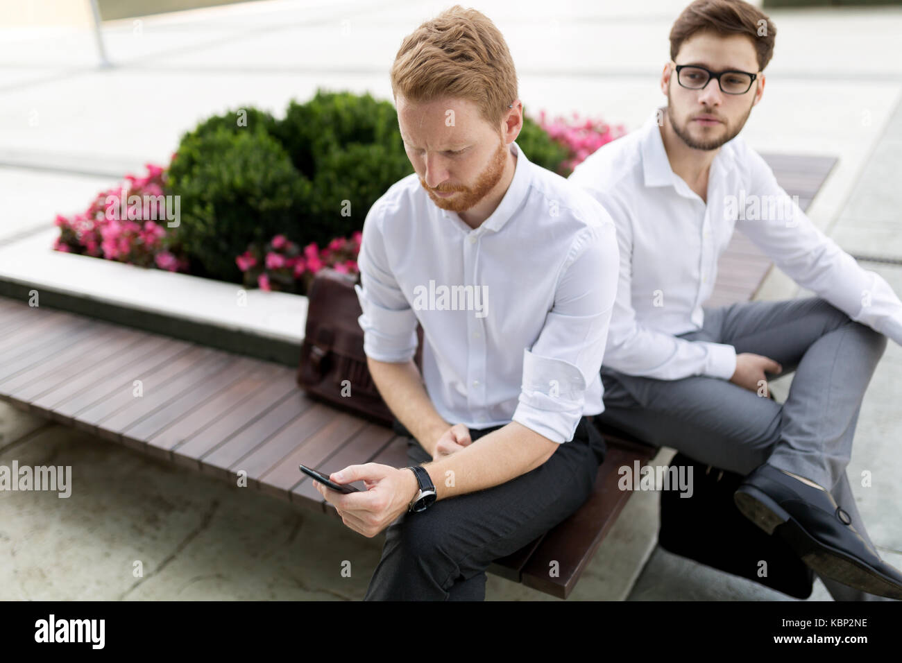 Business colleagues sitting on bench Stock Photo - Alamy Business colleagues sitting on bench Stock Photo - Alamy
