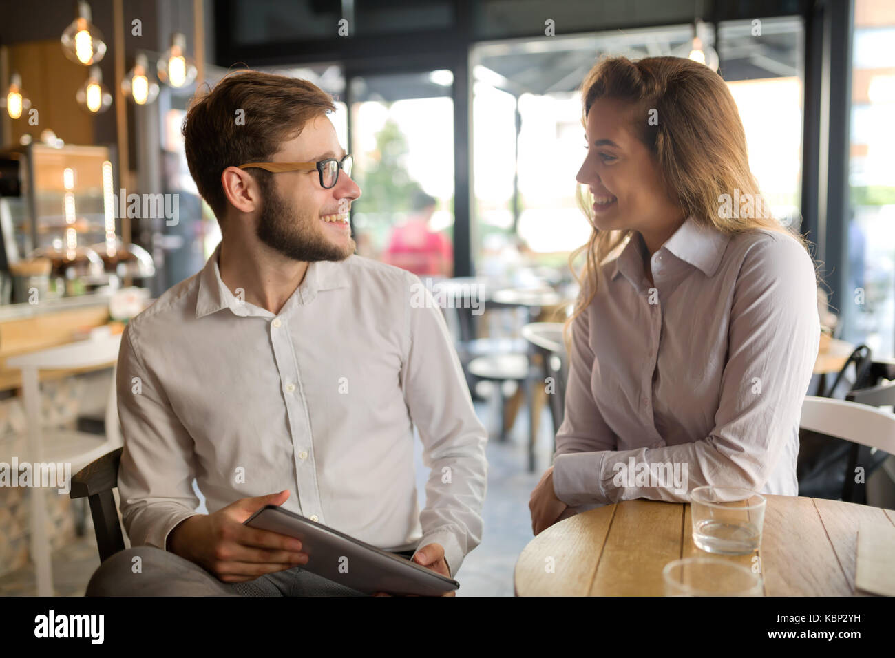 Business people talking and laughing together Stock Photo - Alamy
