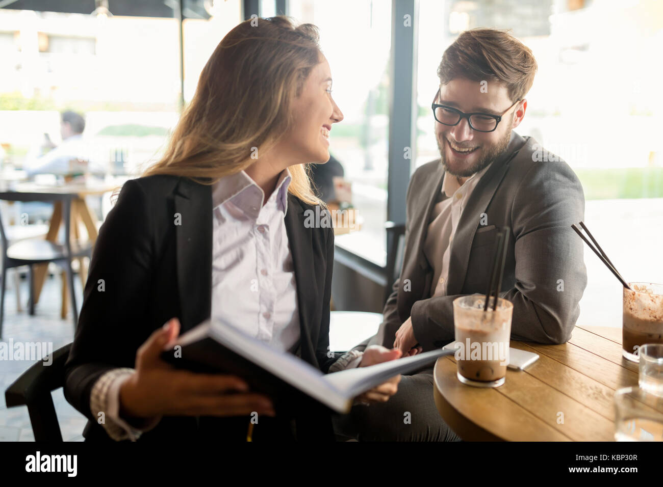 Business people talking and laughing together Stock Photo - Alamy