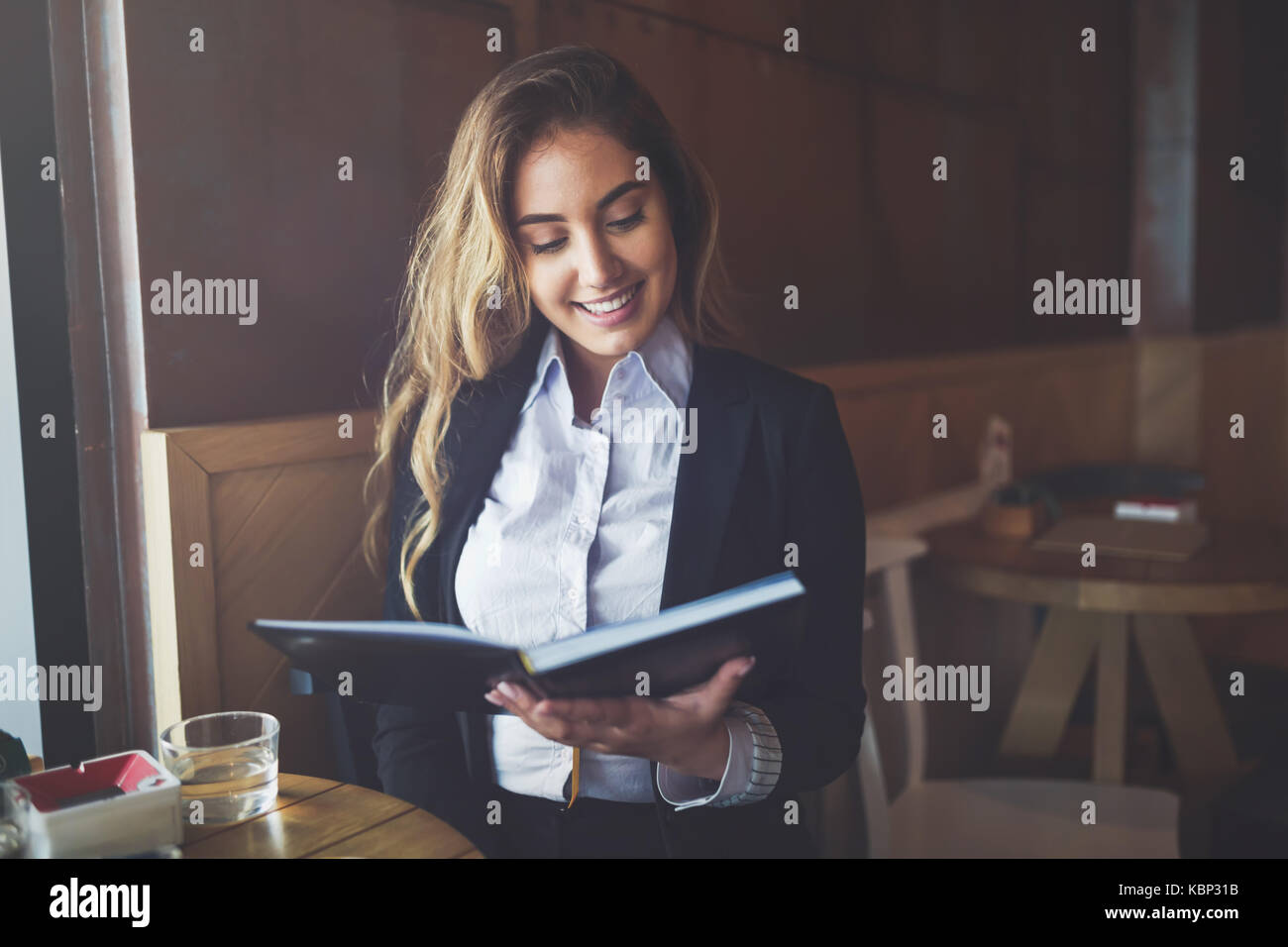 Beautiful woman reading notebook Stock Photo - Alamy