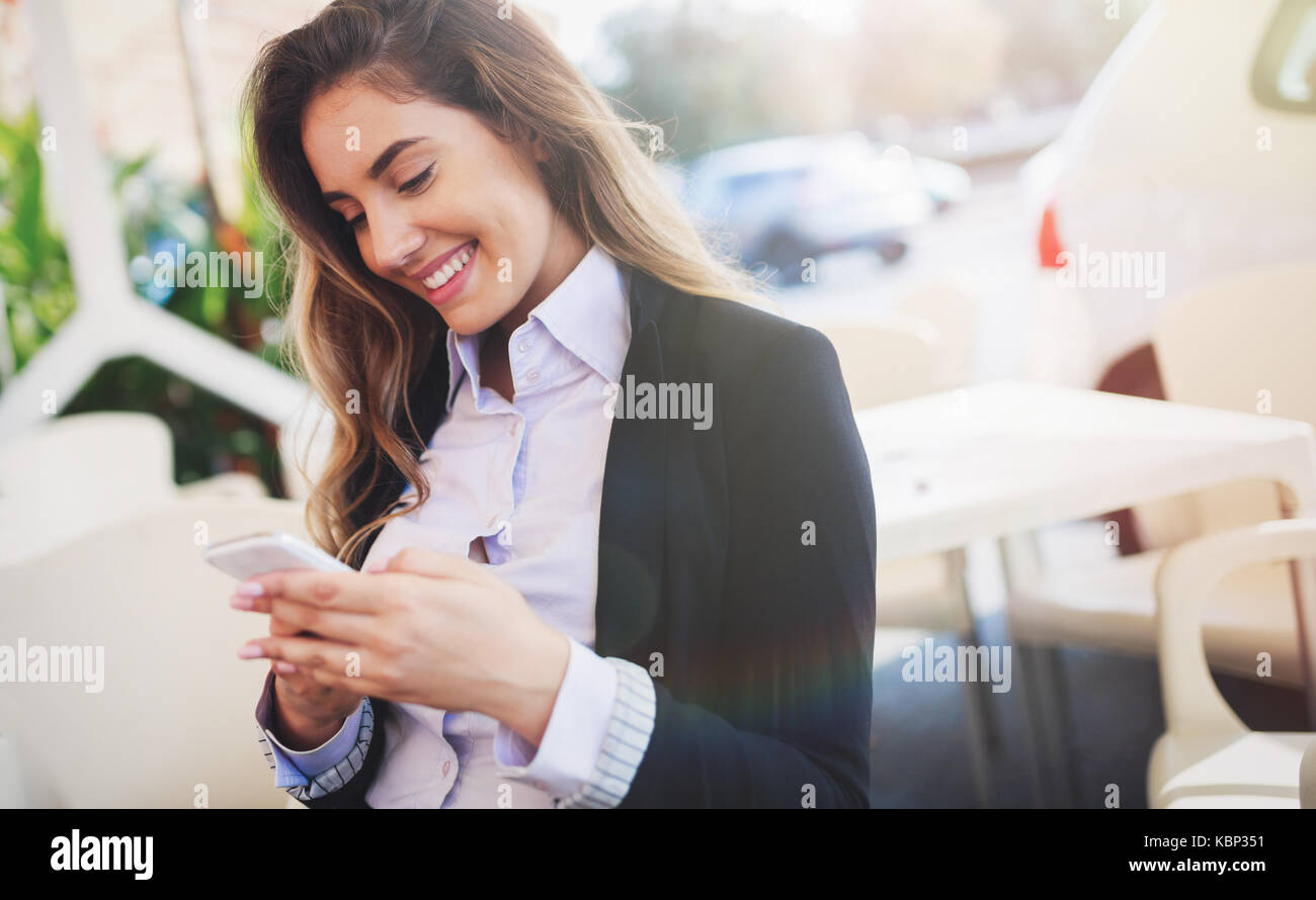 Beautiful woman using cellphone to text Stock Photo - Alamy