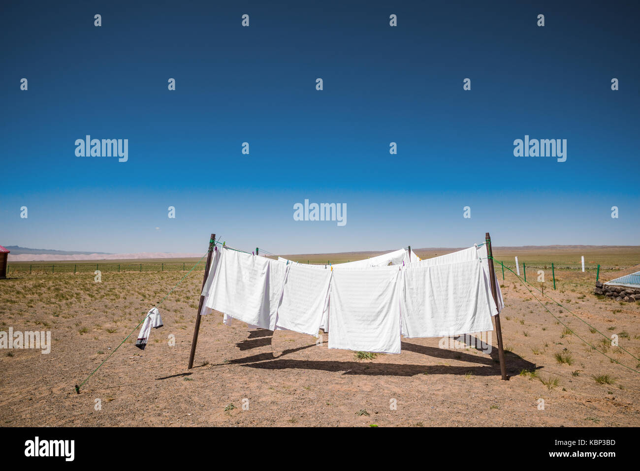 Clothes on clotheslines drying on sun in middle of field Stock Photo ...