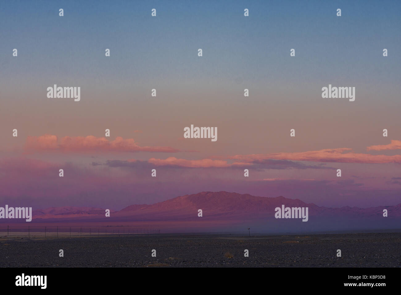 panoramic view of beautiful green plain at root of mountains at dusk ...