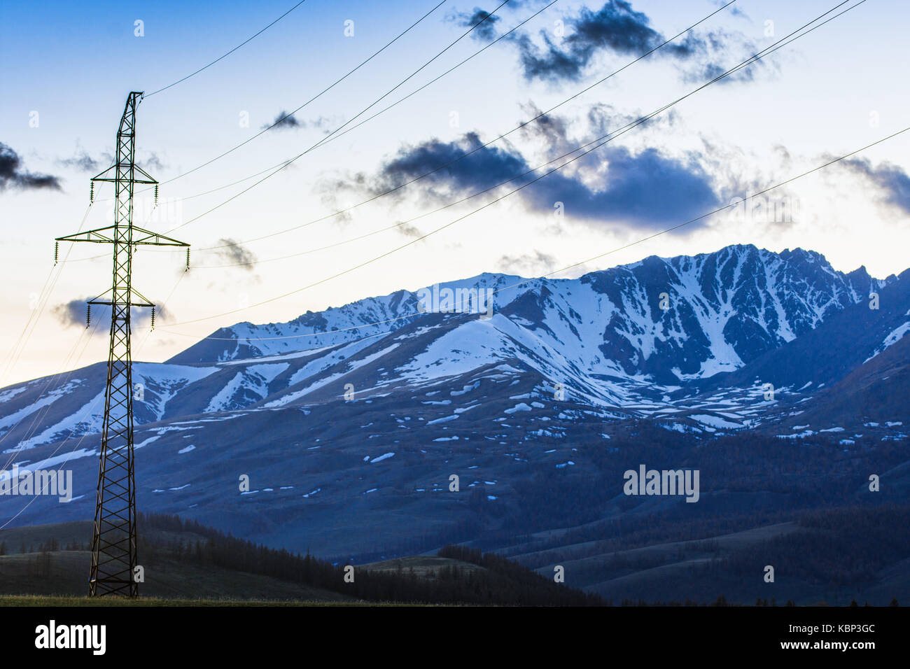 High voltage transmission towers with mountains on background Stock ...