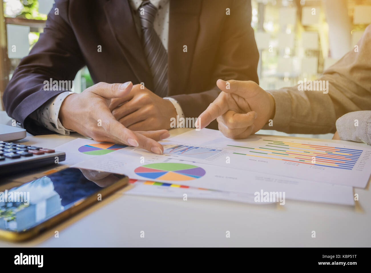 Two colleagues discussing about new business project plan on office in ...