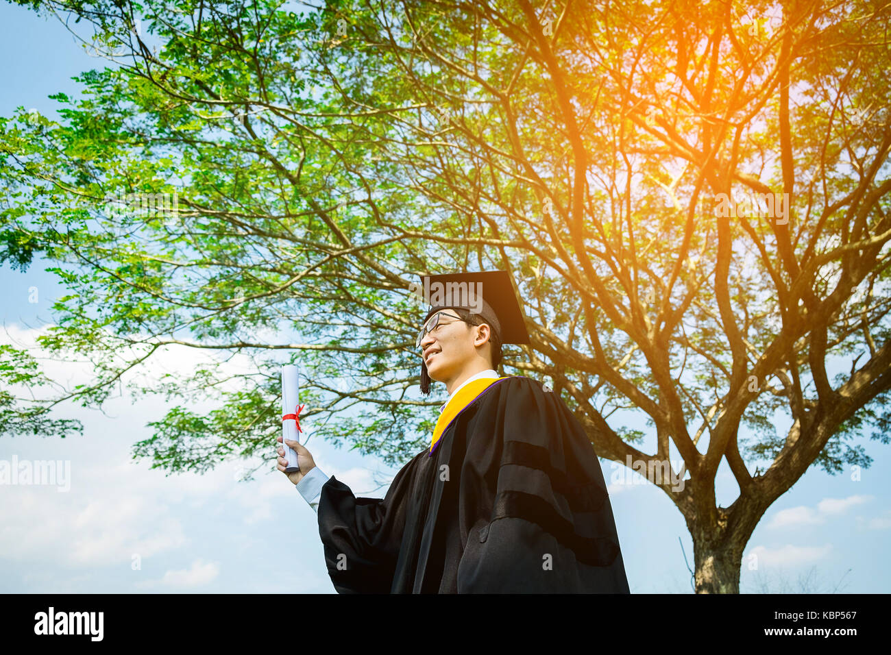 Graduation: Student standing up and smile holding Graduation ...
