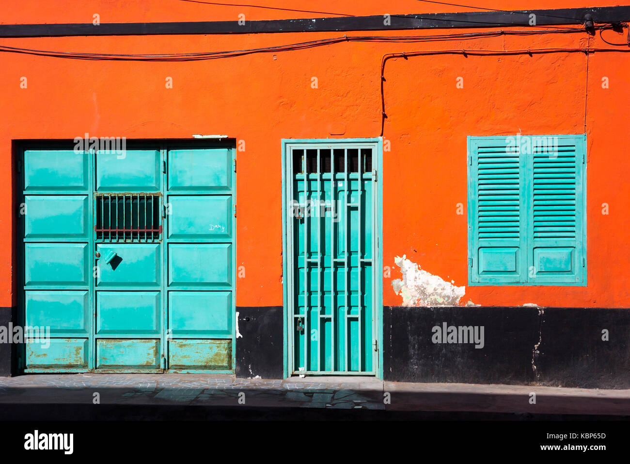 Orange wall, cyan windows and door. Colorful Cape Verde architecture ...