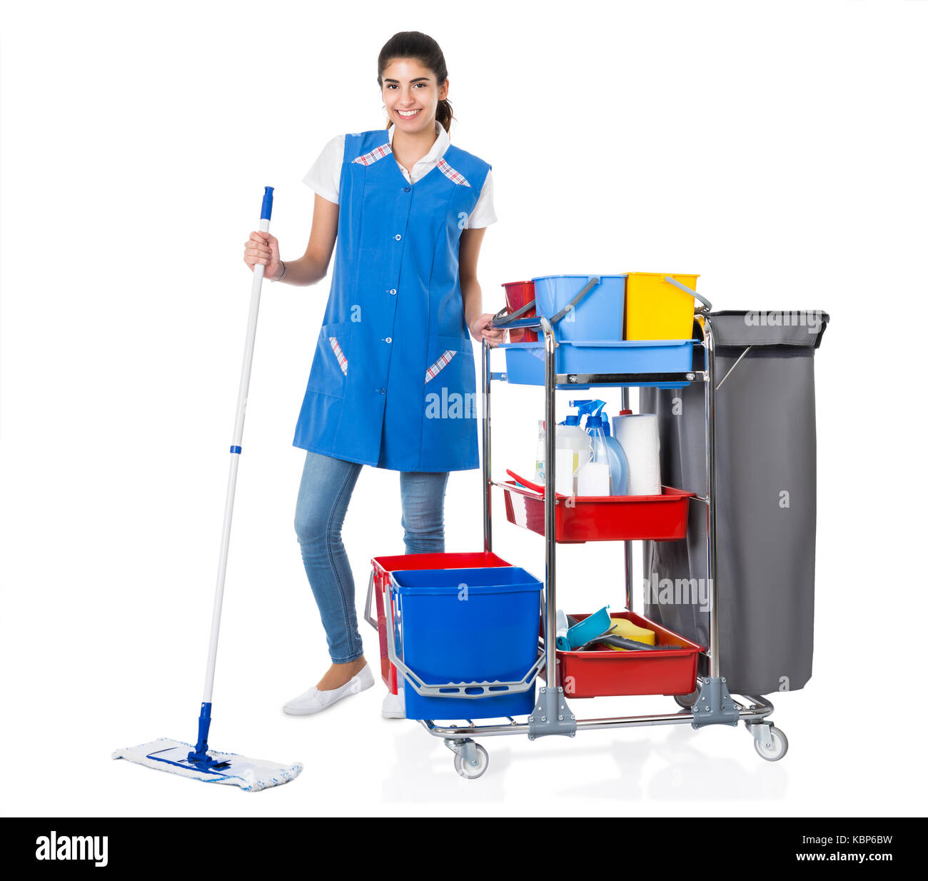 Full length portrait of happy female janitor mopping by trolley on ...