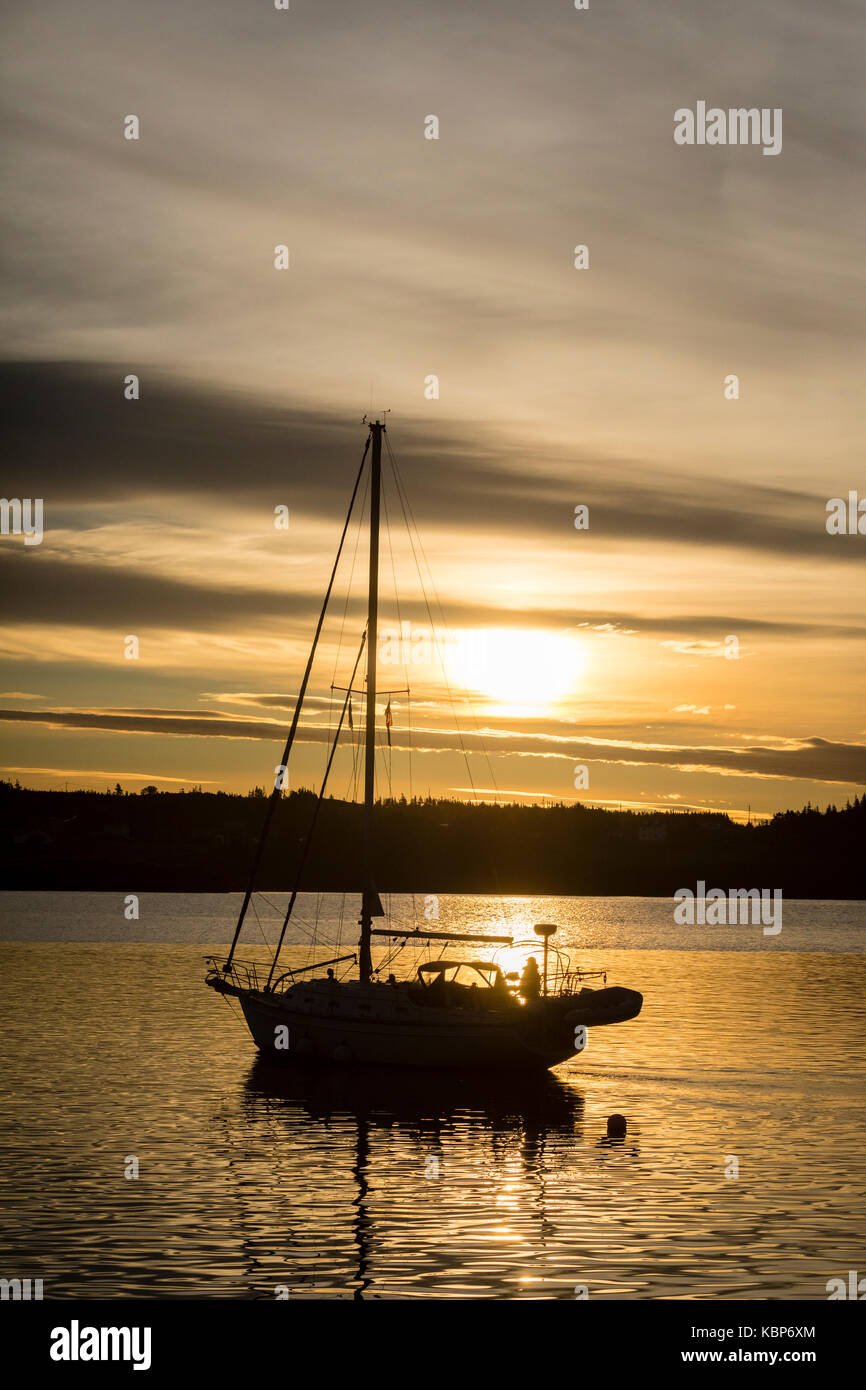 Sailboat leaving harbour early in the morning Stock Photo - Alamy