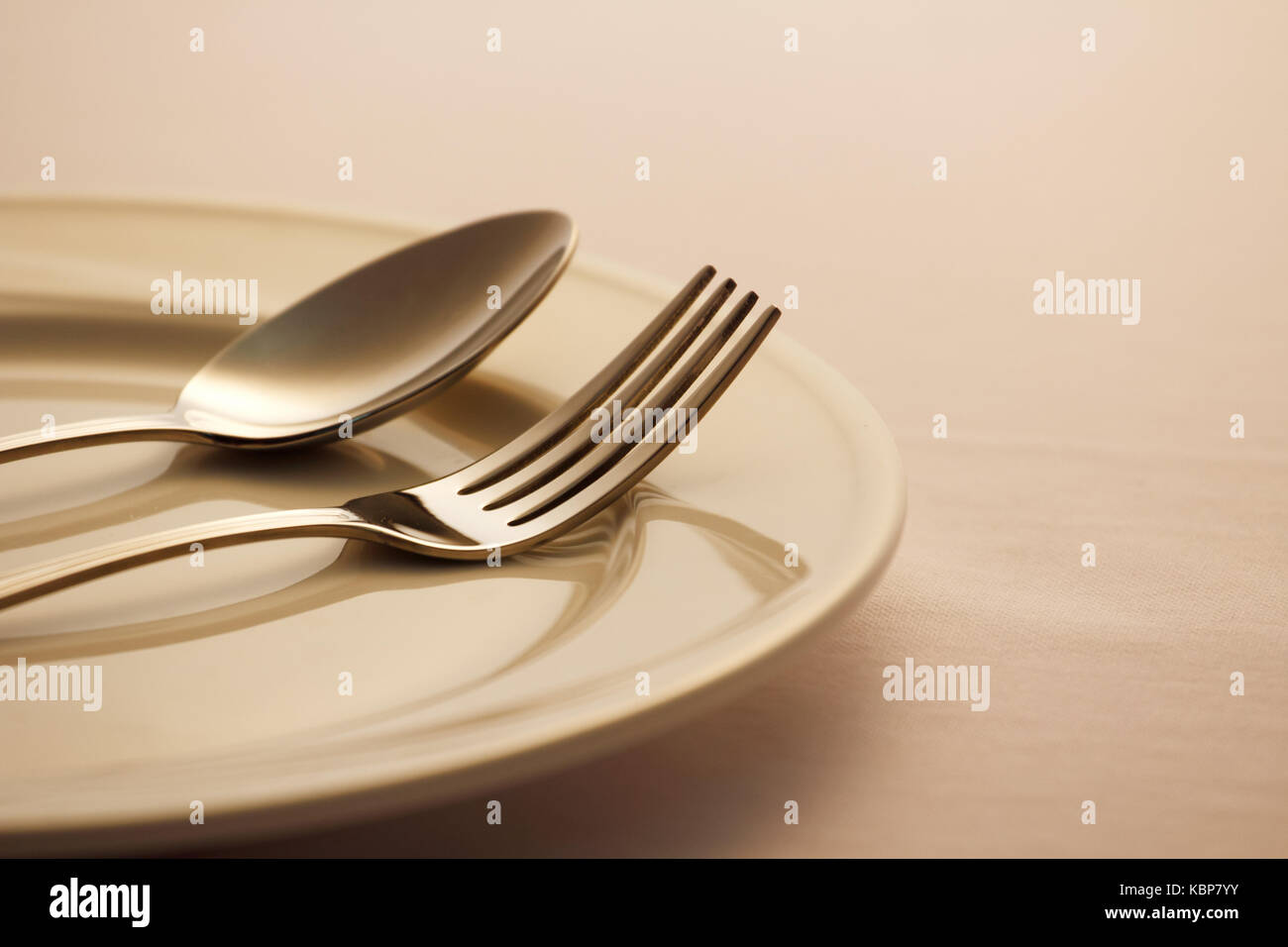 Spoon and fork on the dish Stock Photo - Alamy