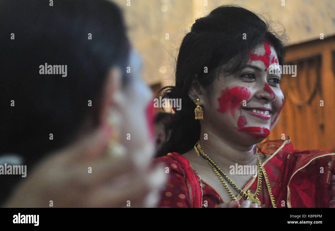 Agartala, India. 30th Sep, 2017. Hindu women smear vermilion powder on ...