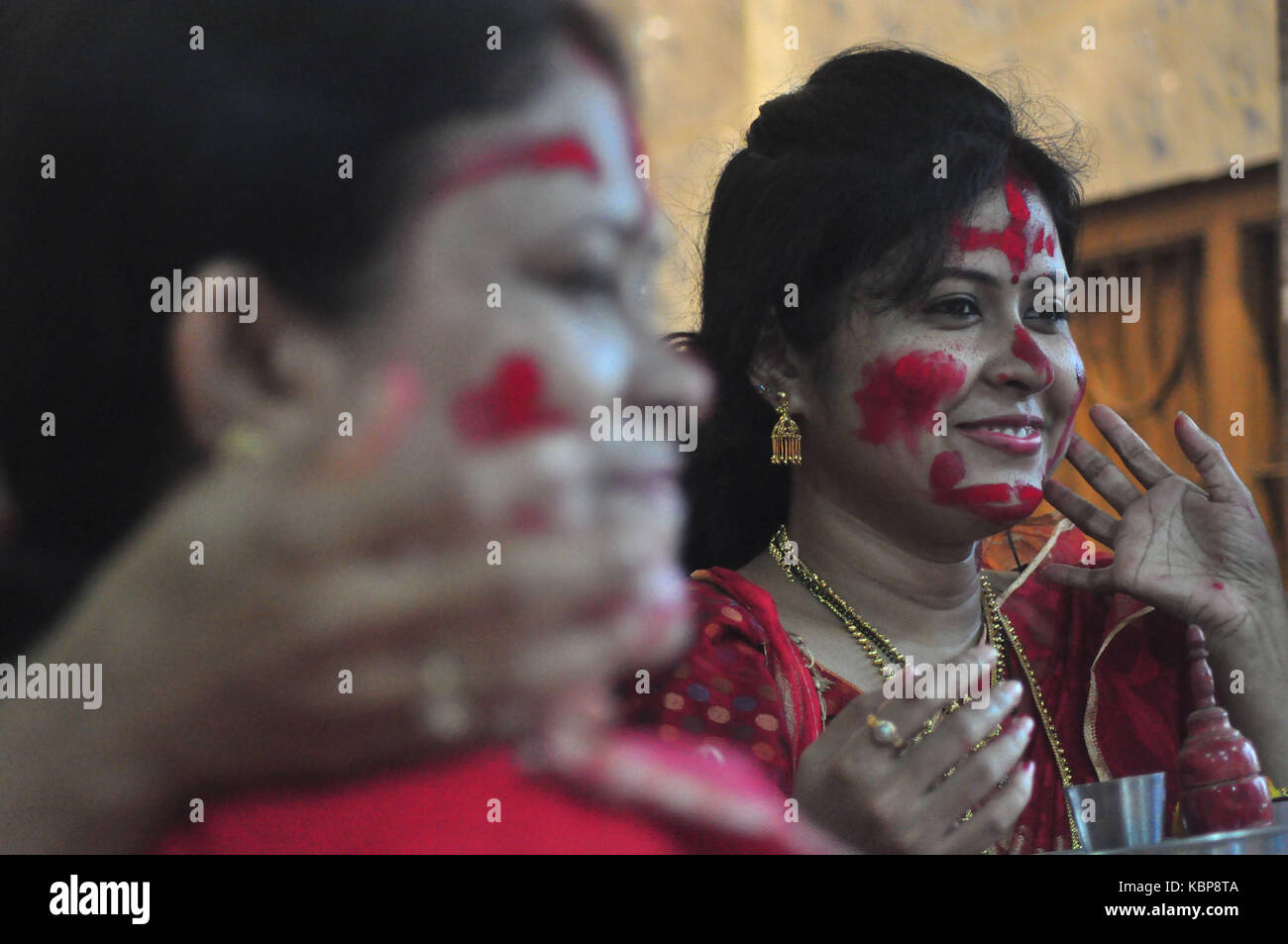Agartala, India. 30th Sep, 2017. Hindu women smear vermilion powder on ...