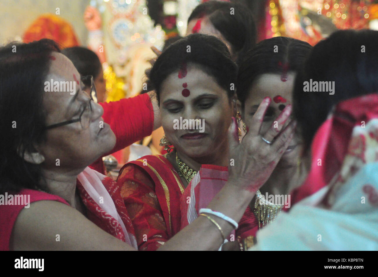 Agartala, India. 30th Sep, 2017. Hindu women smear vermilion powder on ...