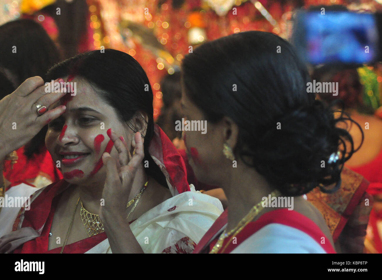 Agartala, India. 30th Sep, 2017. Hindu women smear vermilion powder on ...