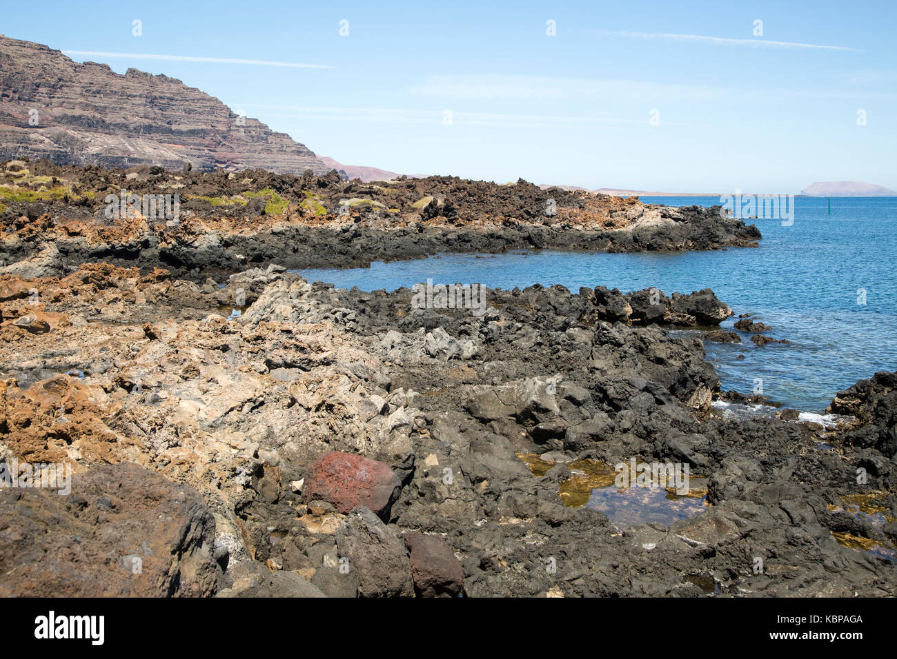 Rocky shoreline on cast at Orzola, Lanzarote, Canary Islands, Spain ...