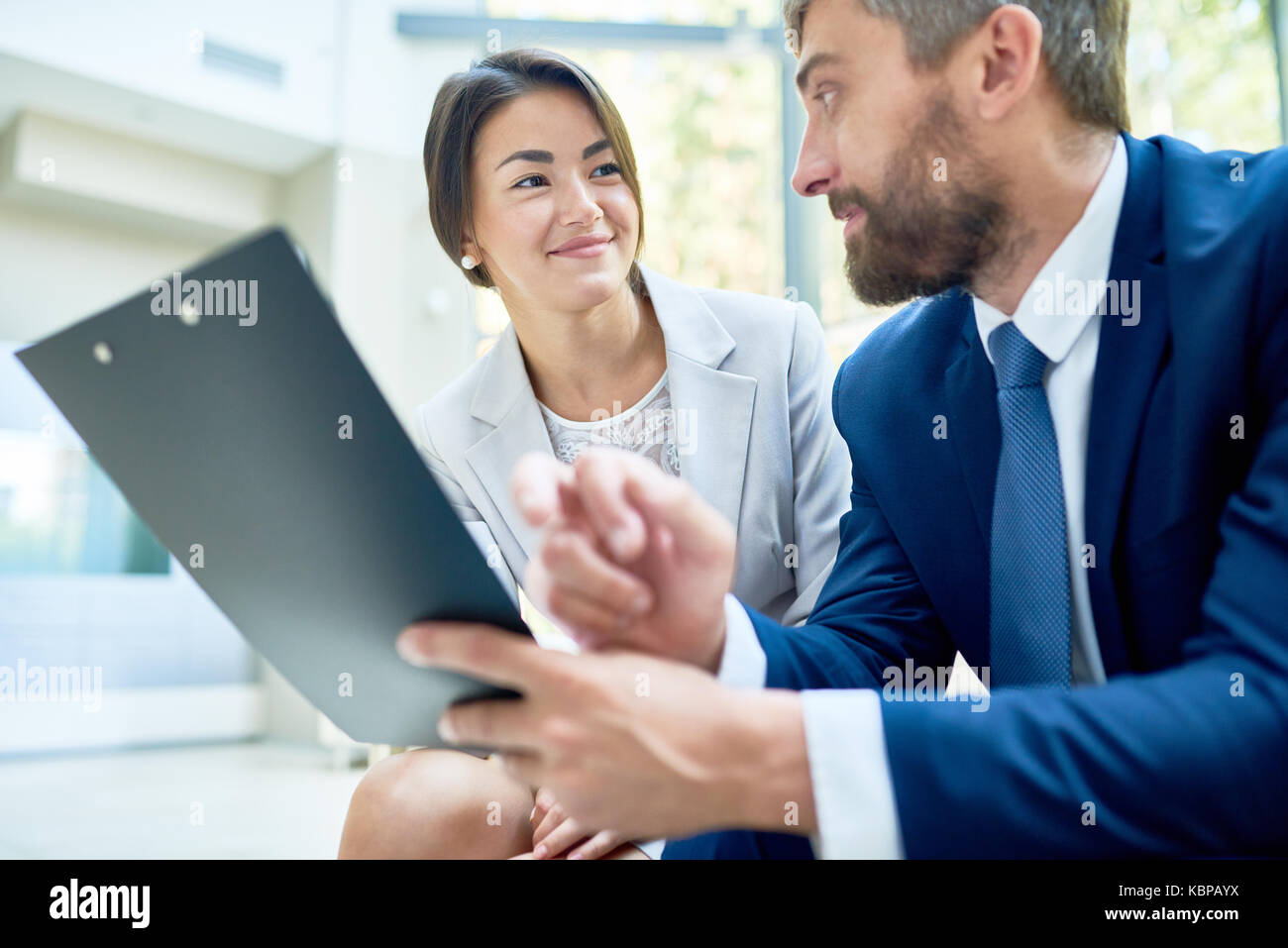 Group of hard-working colleagues brainstorming on joint project while ...