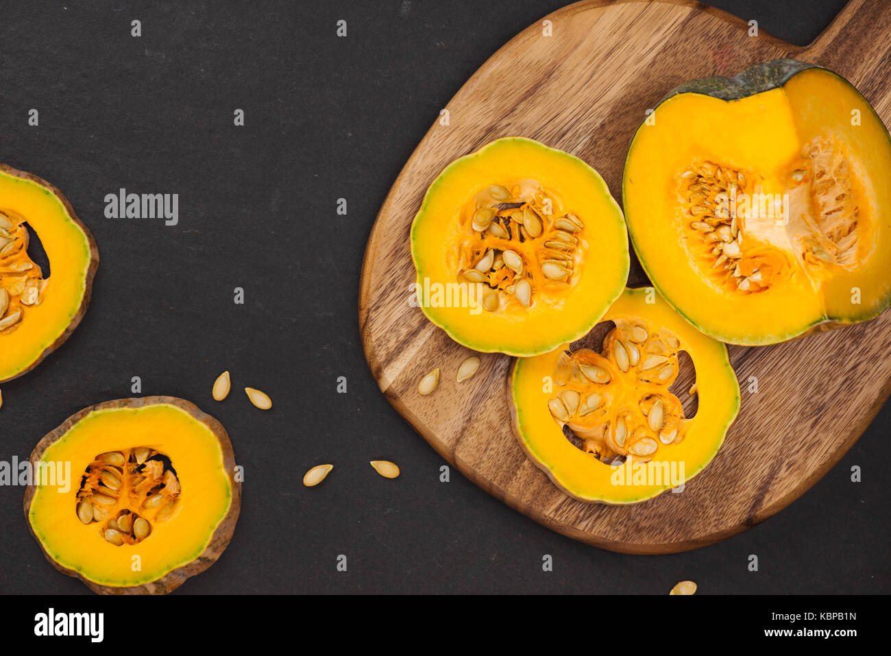 Delicious fresh pieces of ripe pumpkin on wooden background Stock Photo - Alamy
