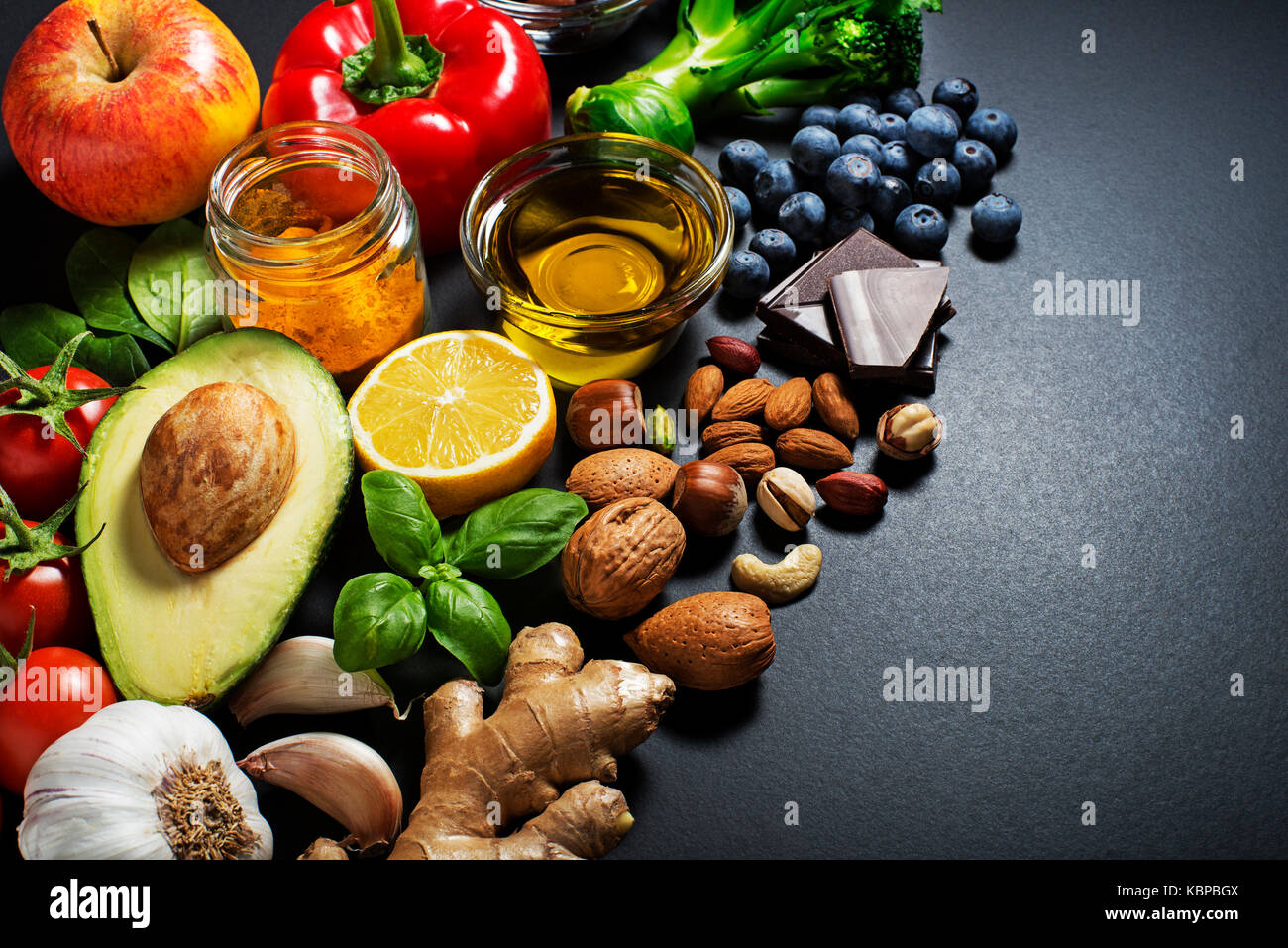 Mixed of fresh healthy food on dark background Stock Photo - Alamy