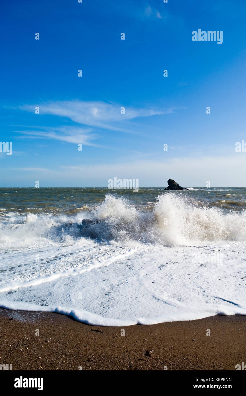 White waves on a sandy beach - Meadfoot beach, Torquay, Devon with East ...
