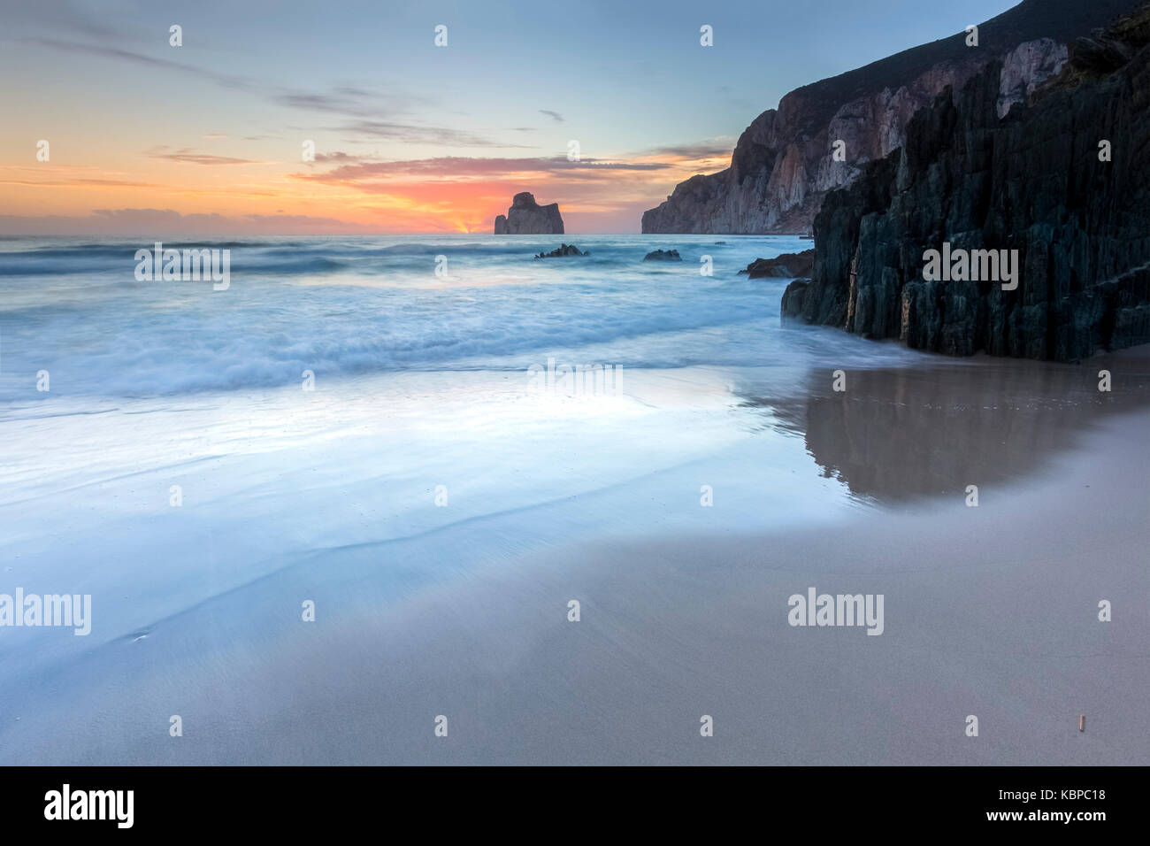 Sunset at Masua beach, in front of the Pan di Zucchero reef. Masua ...