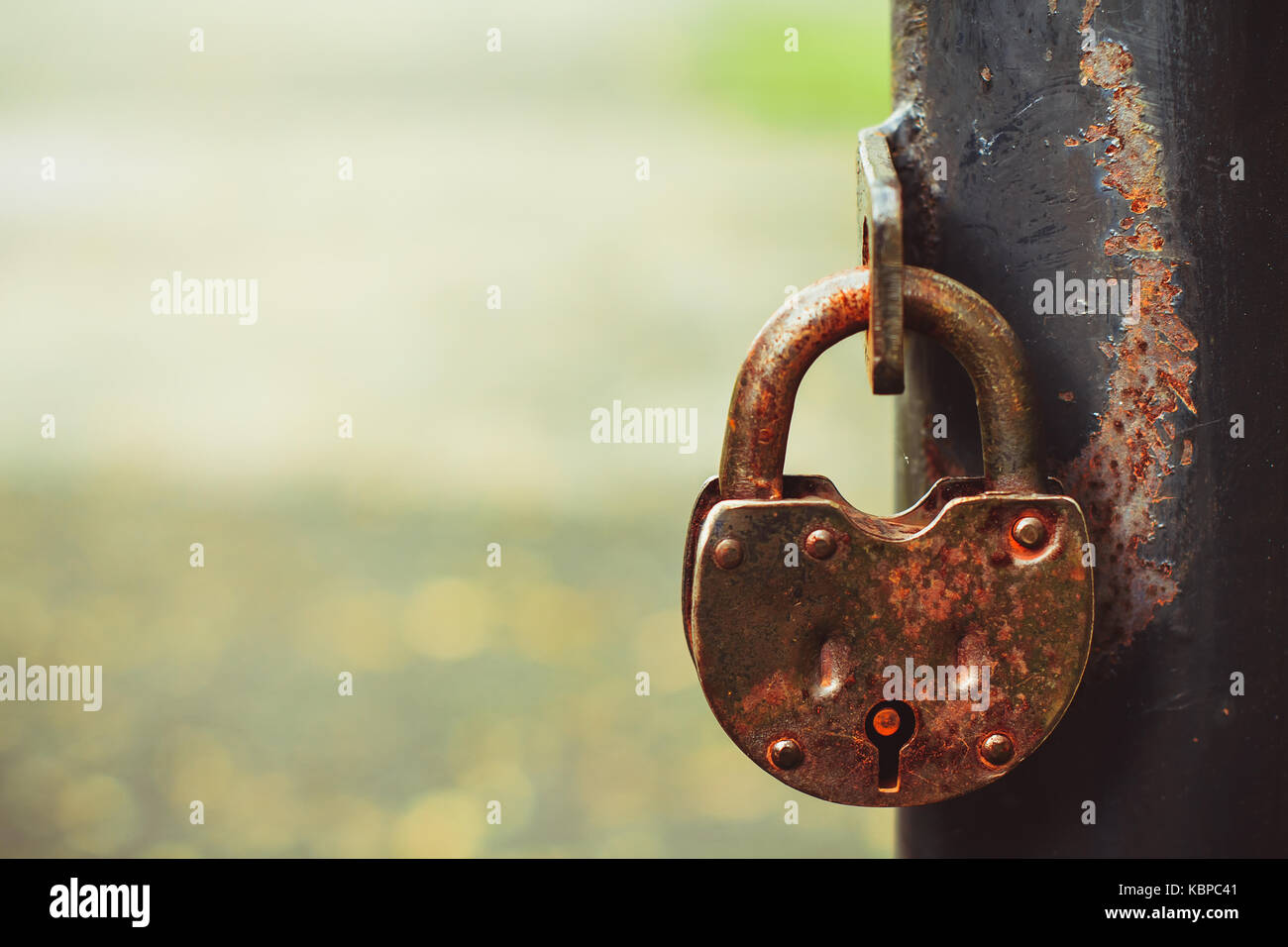 iron lock hanging on the iron fence Stock Photo - Alamy