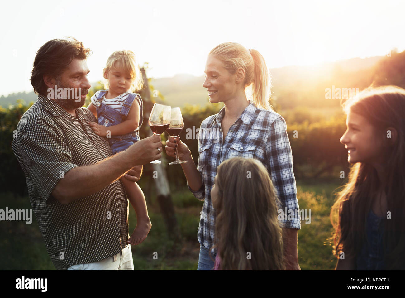 Wine grower family in vineyard before harvesting Stock Photo - Alamy