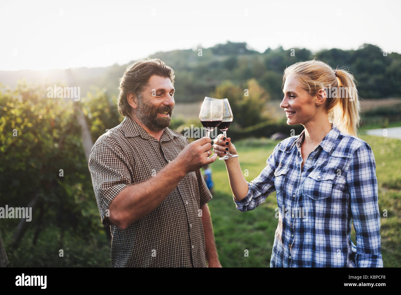 Wine grower family in vineyard before harvesting Stock Photo - Alamy