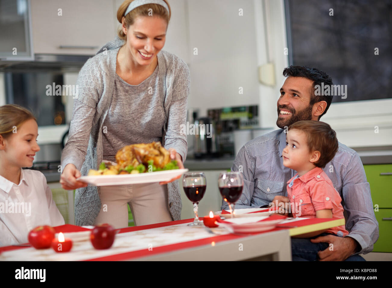 Family together for dinner at home Stock Photo - Alamy
