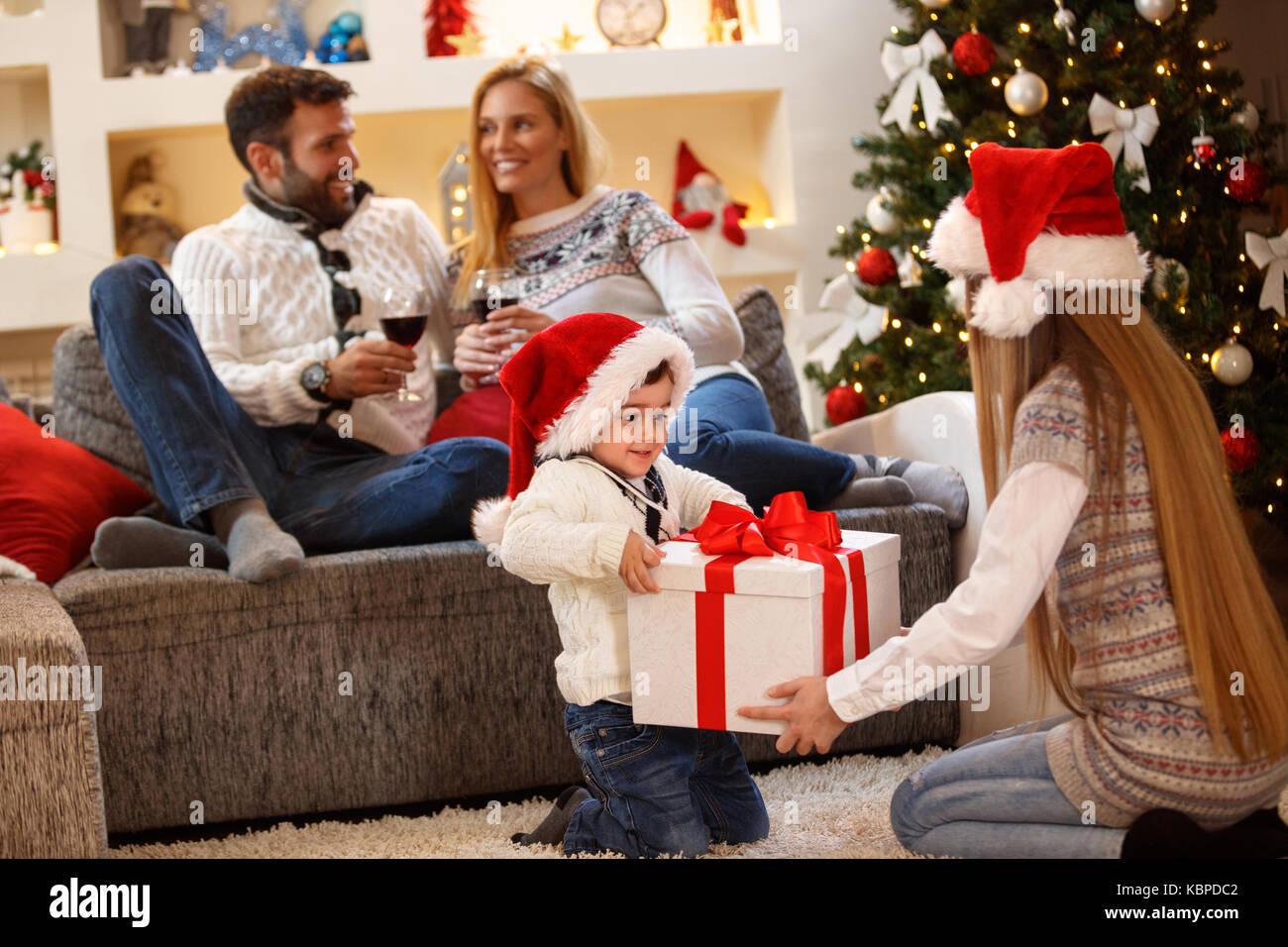 Happy children with Christmas gift enjoying with parents in Christmas ...