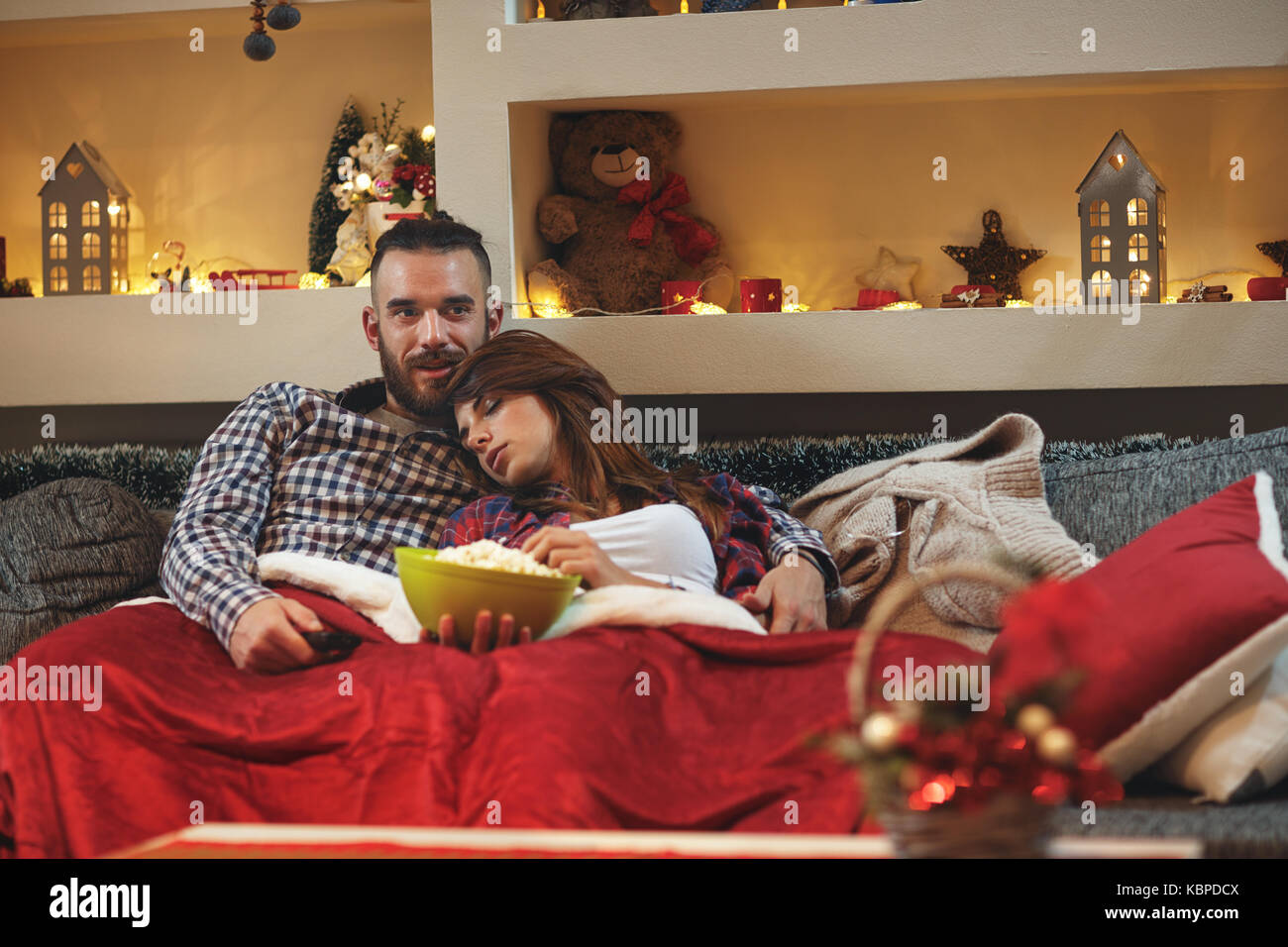 Young woman fall asleep in man`s embrace while watching tv Stock Photo ...