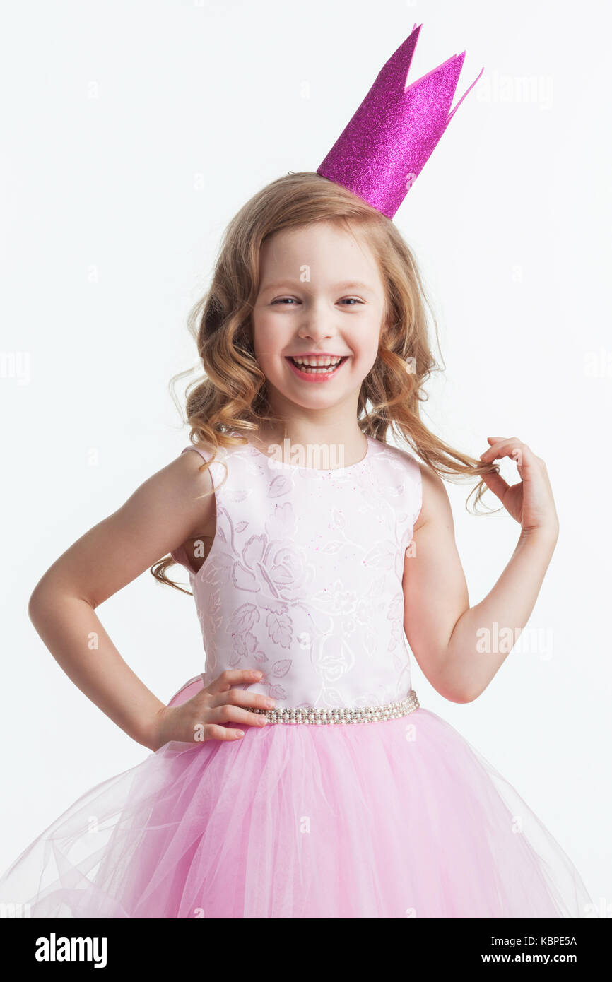 Happy small princess girl in pink dress and crown isolated on white ...
