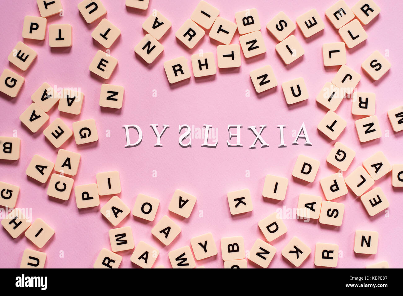 dyslexia concept - alphabet letters on pink background Stock Photo - Alamy