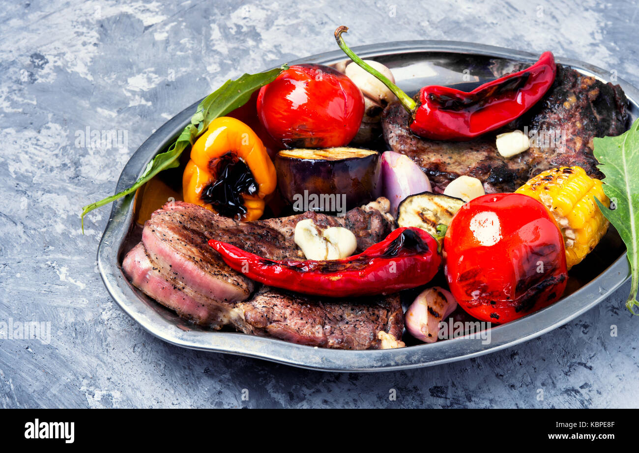 Beef barbecue meat, grilled vegetables on a tray Stock Photo - Alamy