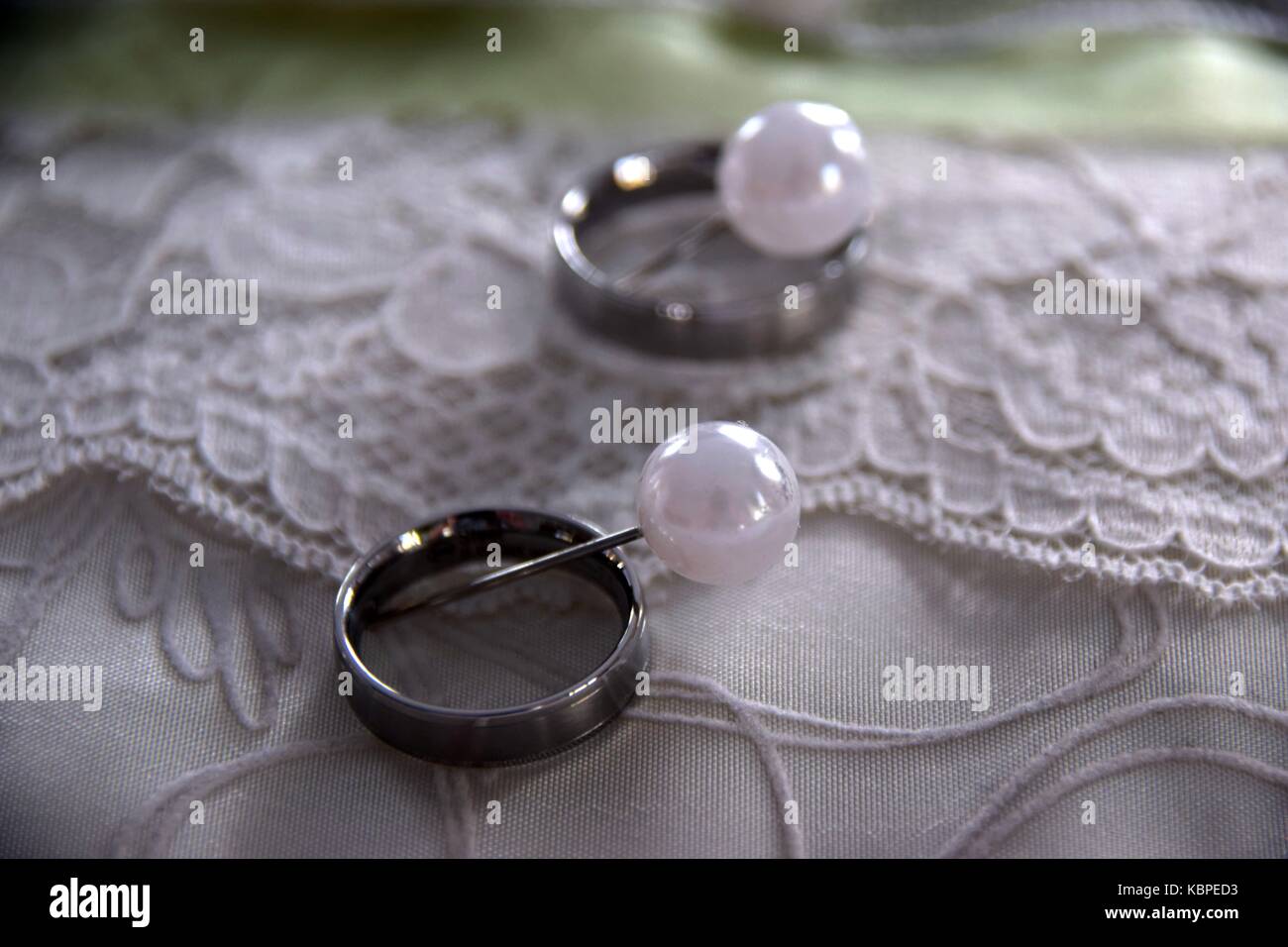 wedding rings on a pillow fixed with needles, Symbol of love at a ...