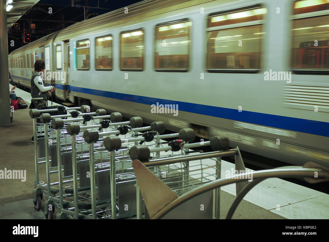 A TER, French Regional Train, arrives at night in a railway station ...