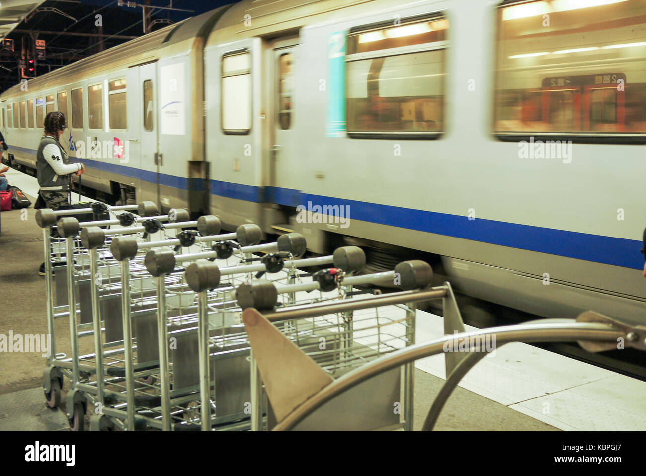 A TER, French Regional Train, arrives at night in a railway station ...