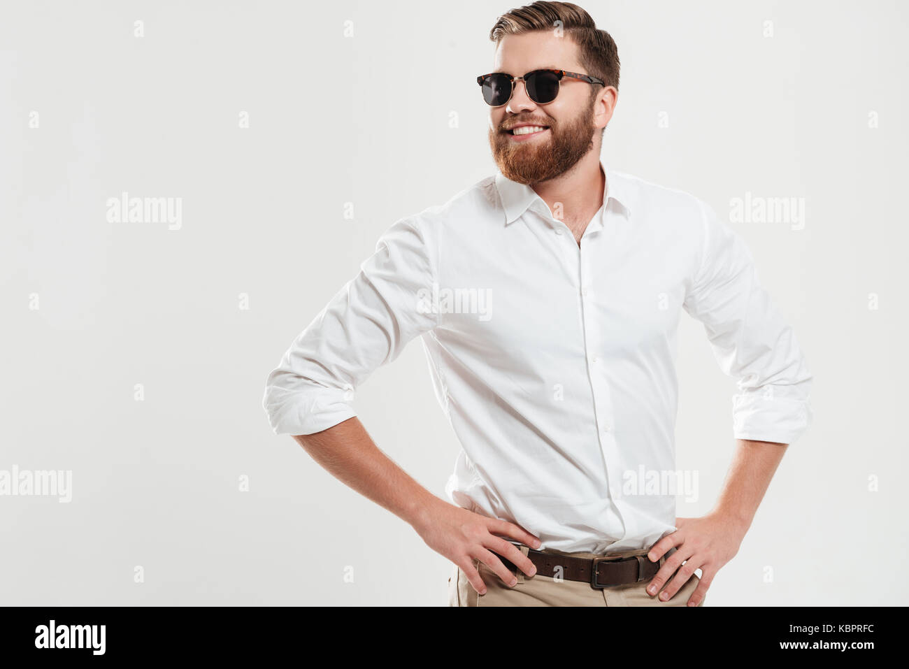 Picture of happy young bearded man standing over white wall background ...