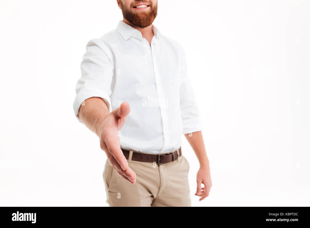 Cropped image of a smiling bearded man greeting someone with his hand ...