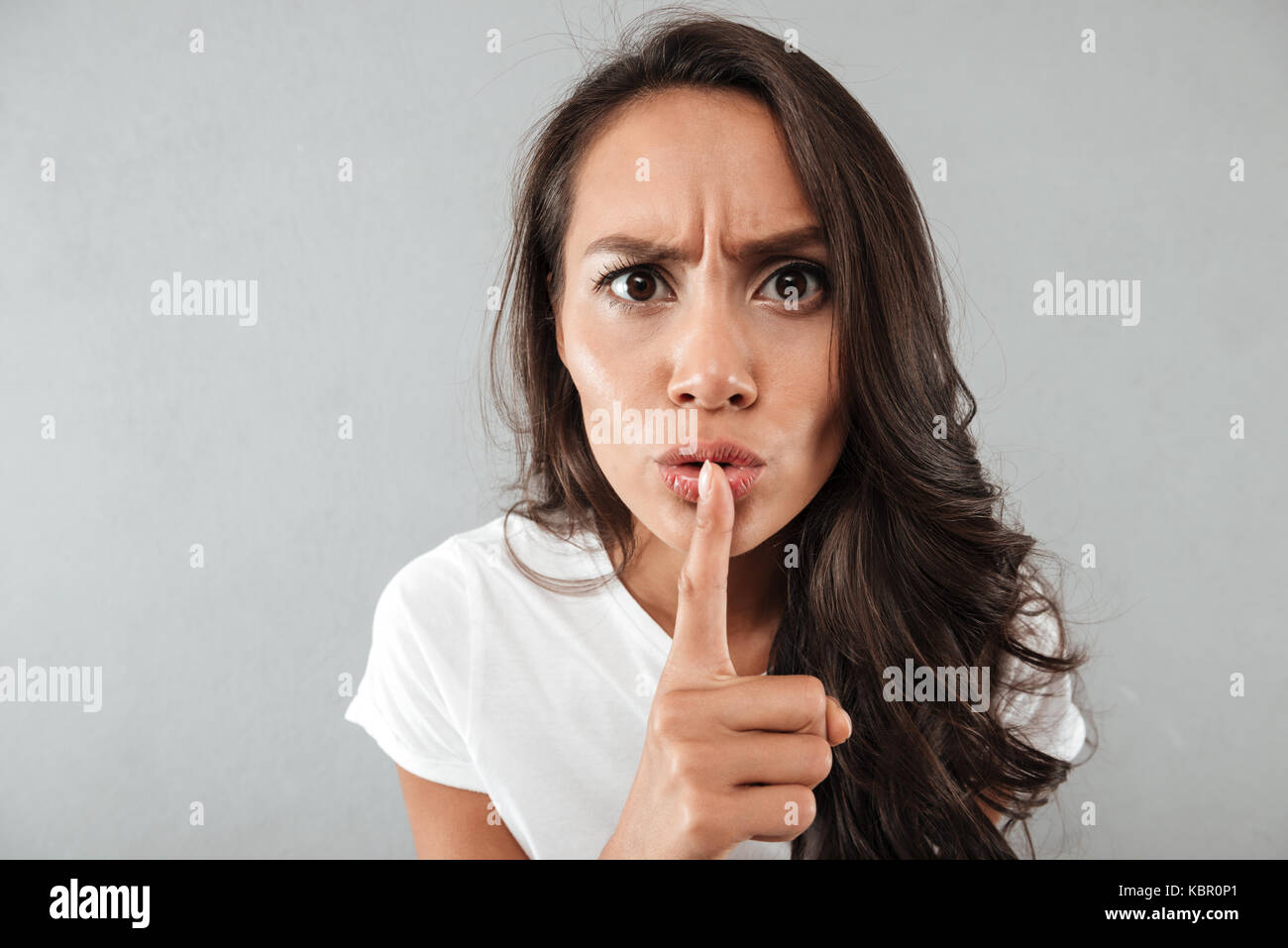 Close up portrait of an annoyed angry asian woman showing silence ...