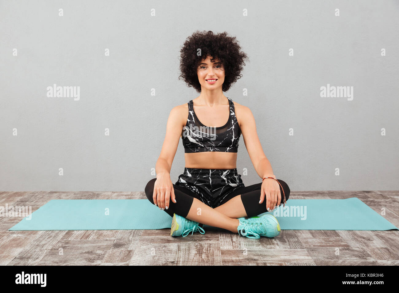 Image of beautiful curly fitness lady make sport yoga exercises over ...