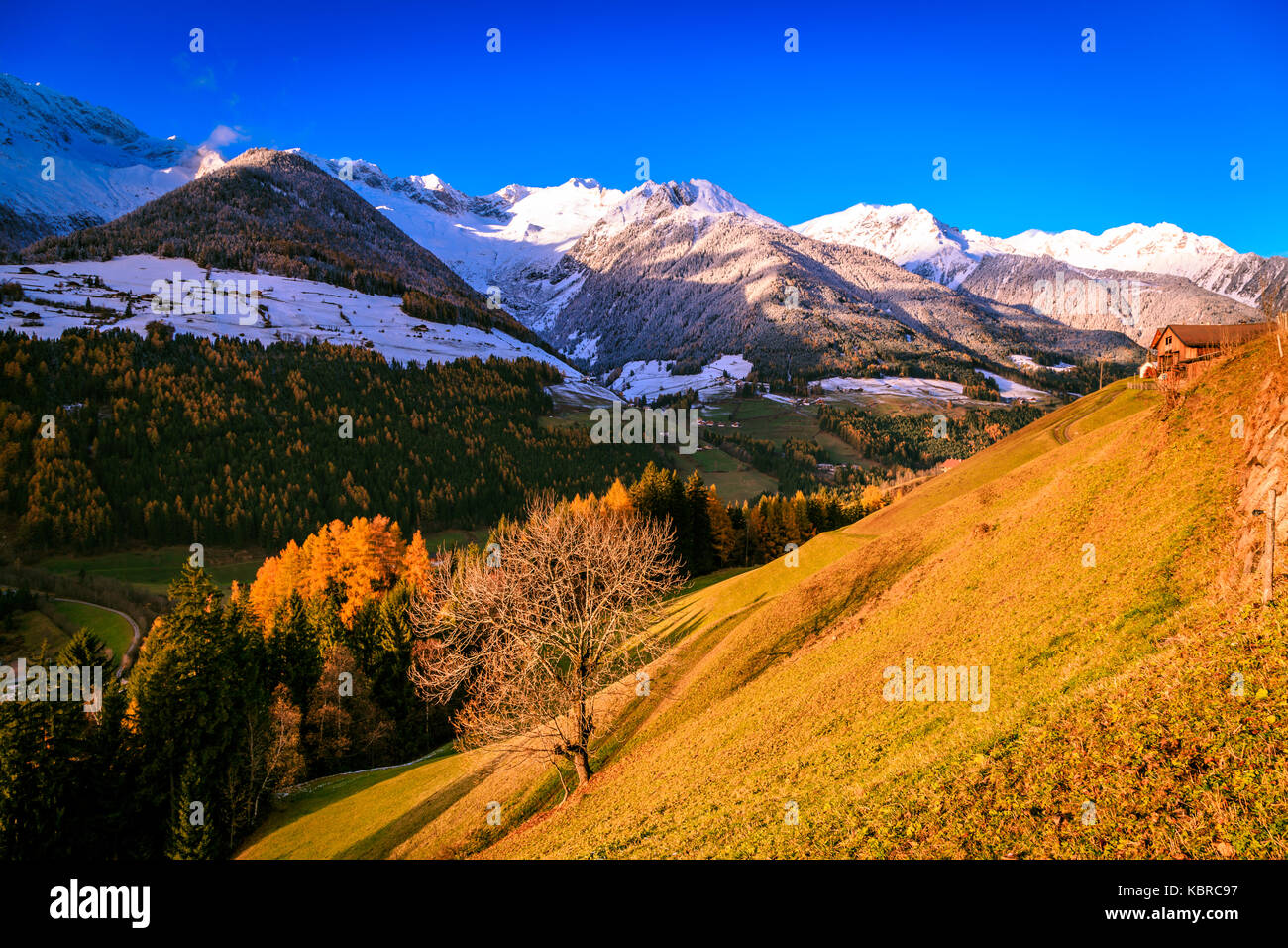 Sun goes down in the alpine valley Stock Photo - Alamy