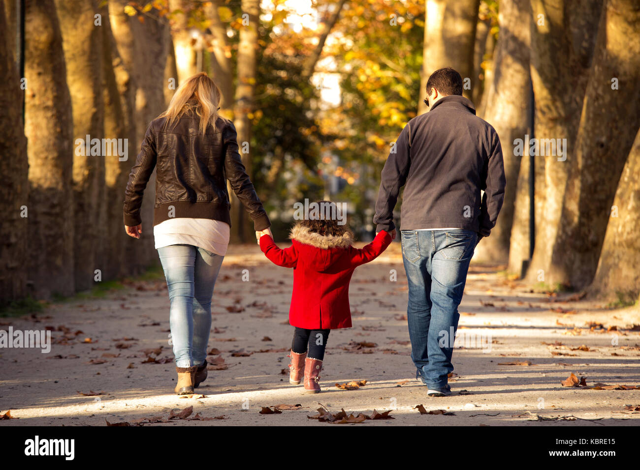 Outdoor portrait of a happy family walking together and enjoying the ...