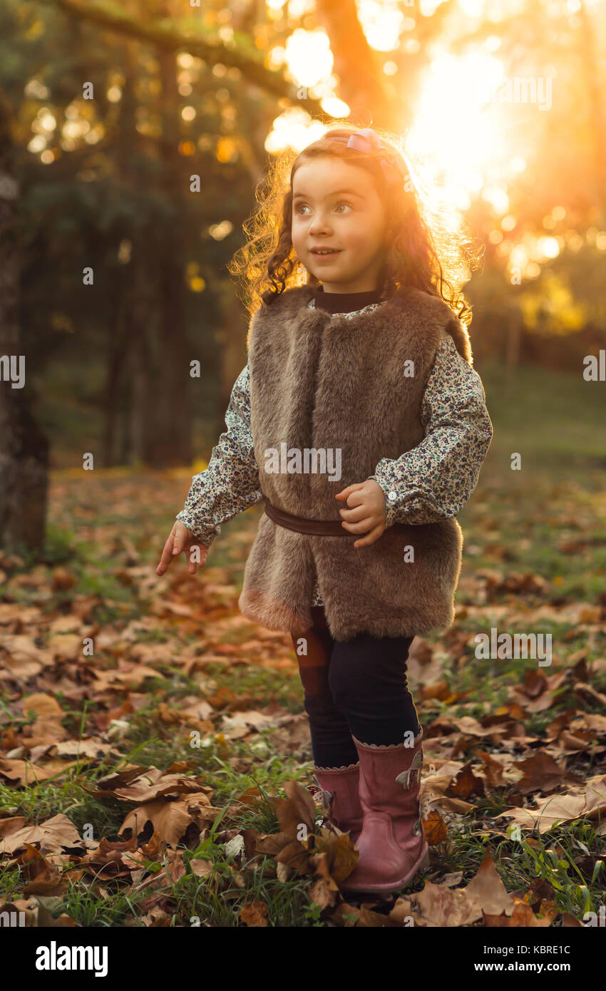 Portrait of a beautiful pretty girl in outdoor enjoying the fall season ...