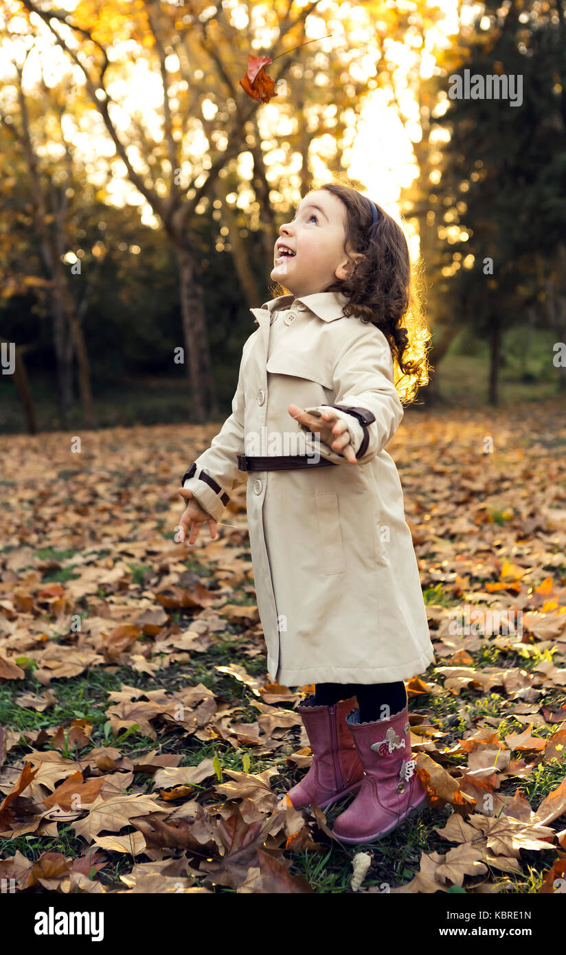 Portrait of a beautiful pretty girl in outdoor enjoying the fall season ...