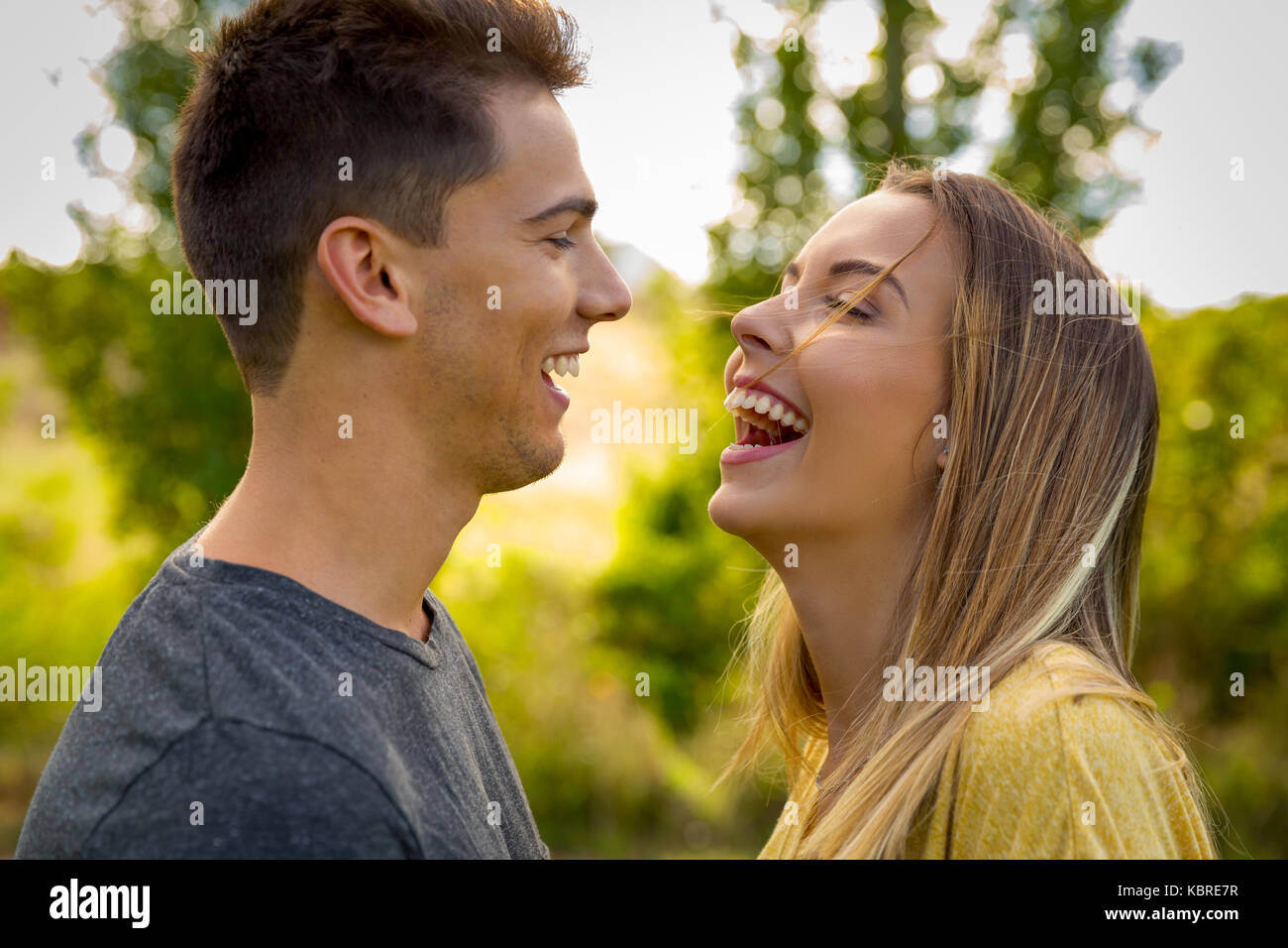 Portrait of a young beautiful couple laughing Stock Photo - Alamy