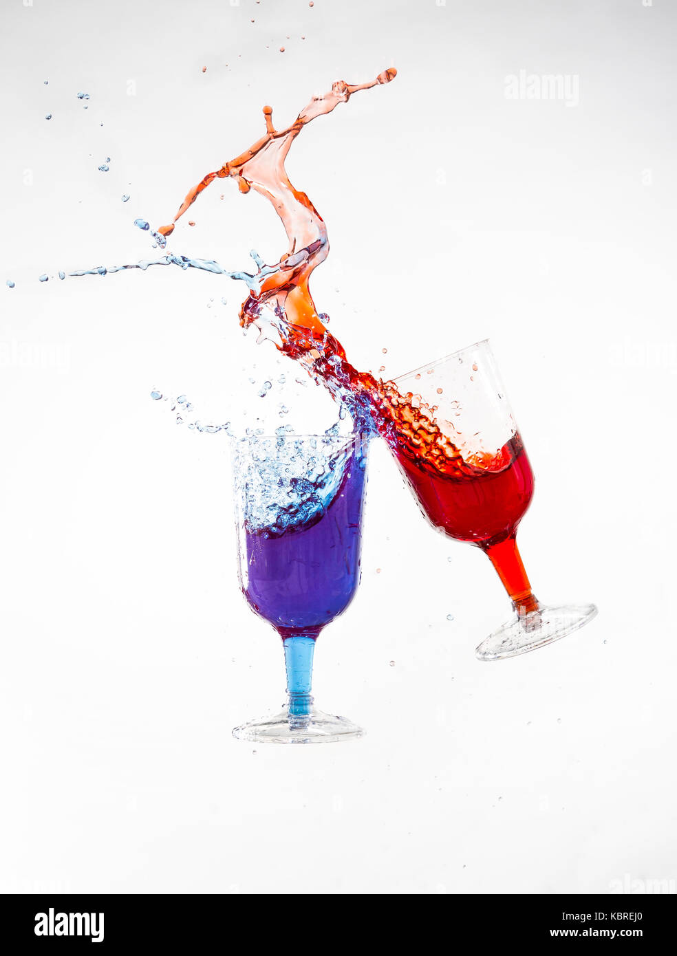 coloured liquid splashing in floating glasses Stock Photo - Alamy