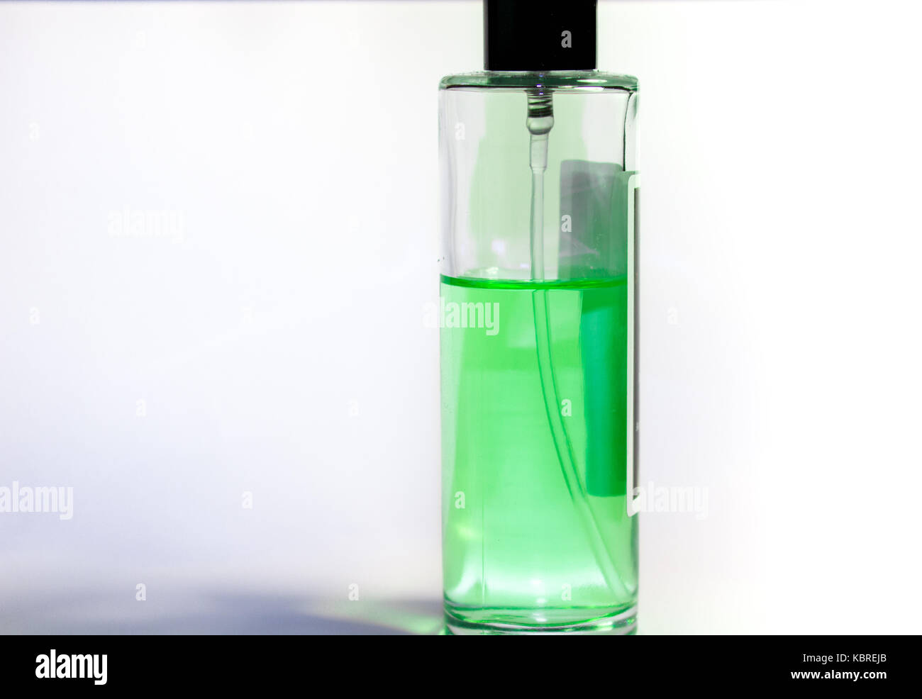 green liquit on a bottle representing a perfume or a science experiment ...